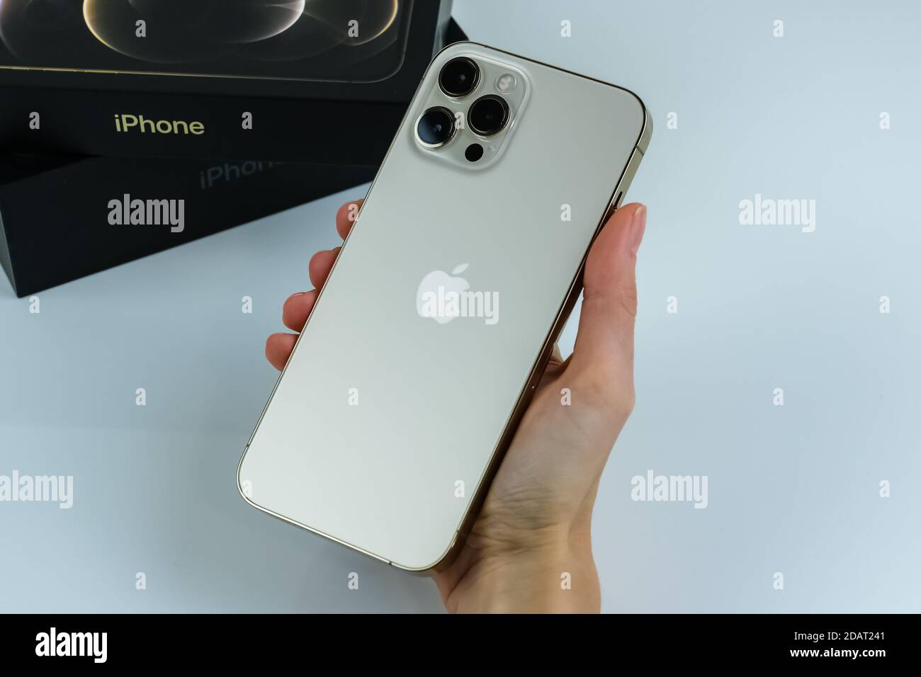 iPhone 12 Pro Max in the gold color in the hand of a customer Stock ...