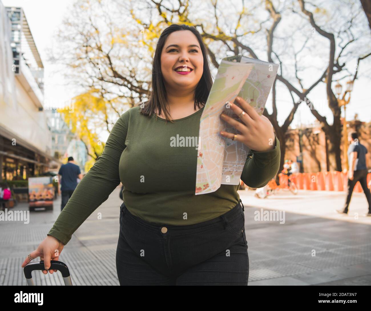 Young woman holding a map and looking for directions Stock Photo - Alamy