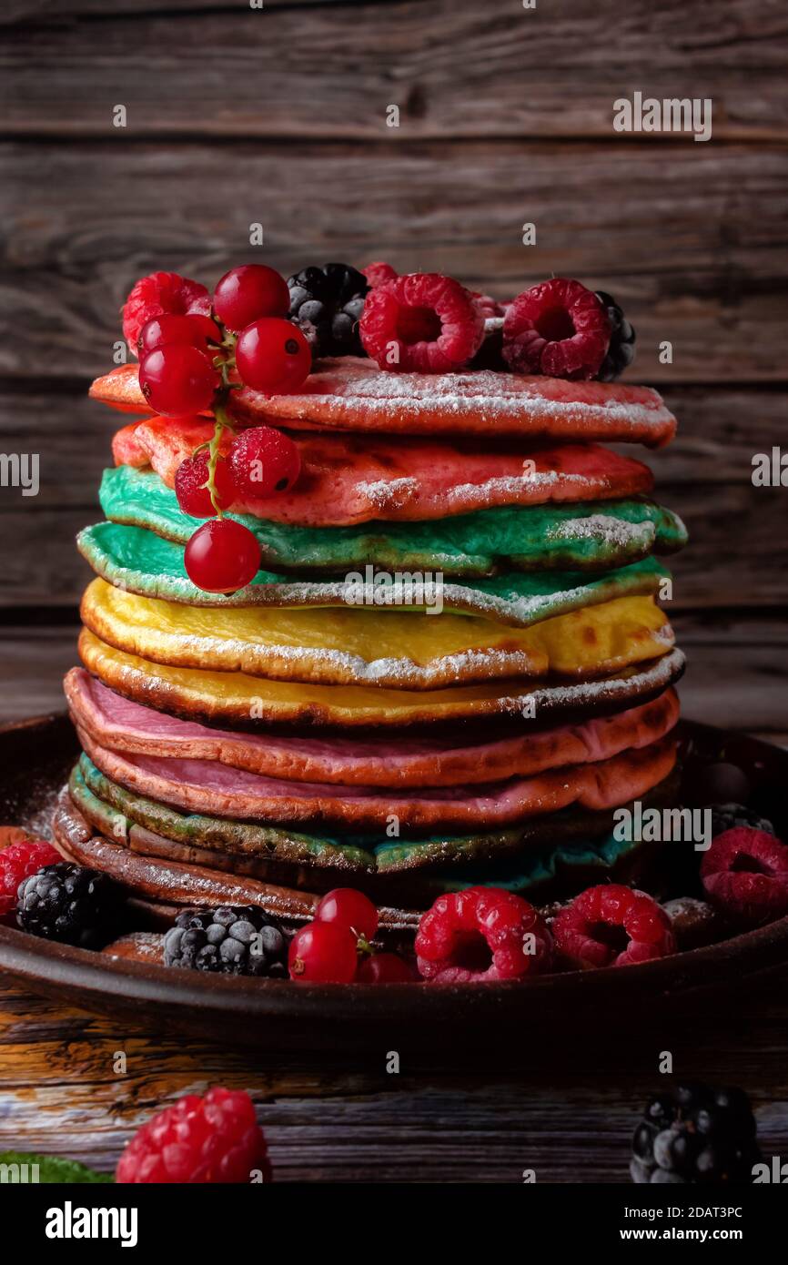 Colored pancakes with fruit, almonds and powdered sugar Stock Photo - Alamy