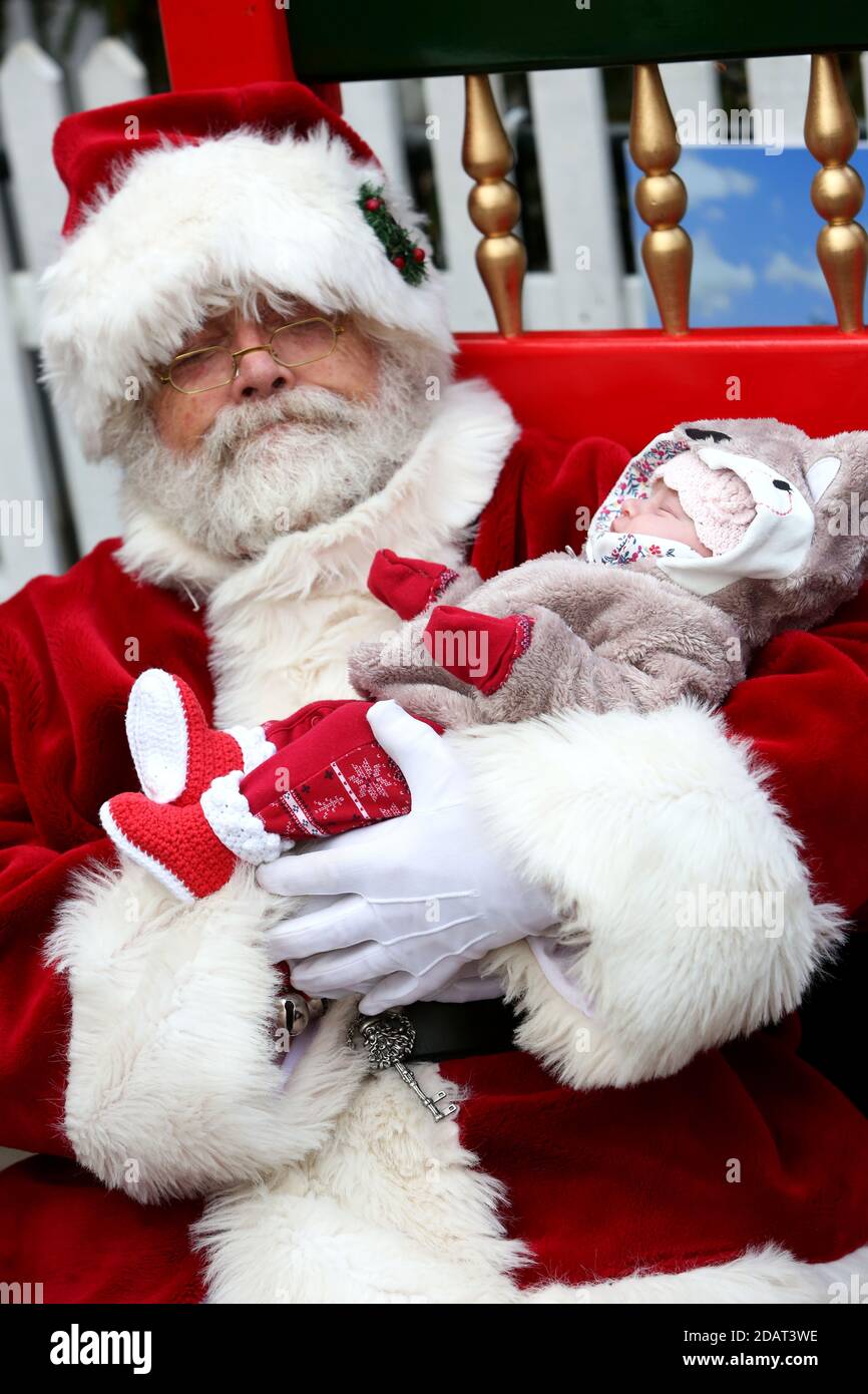 Father Christmas pictured holding a baby for a photograph in Chichester ...