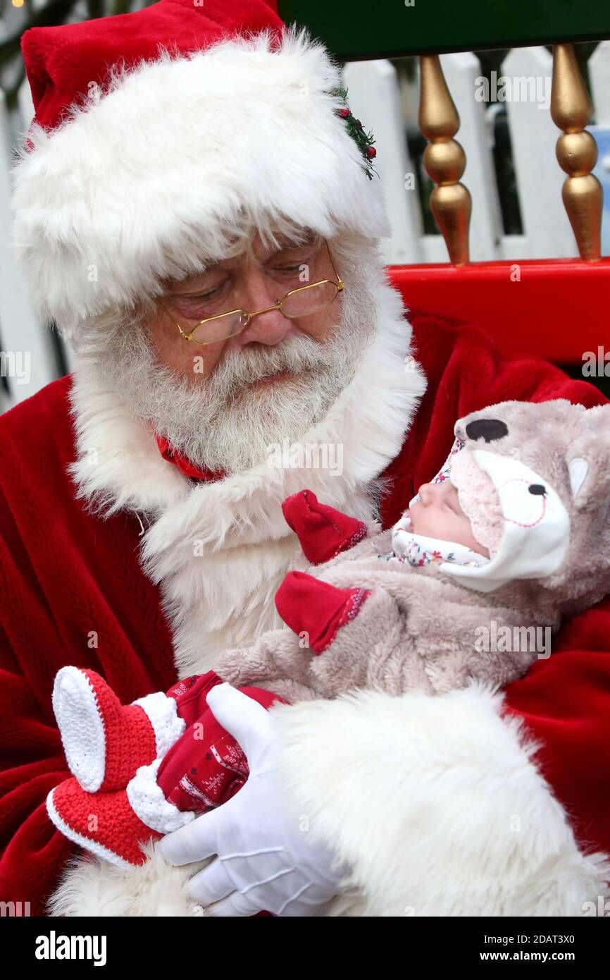 Father Christmas pictured holding a baby for a photograph in Chichester ...