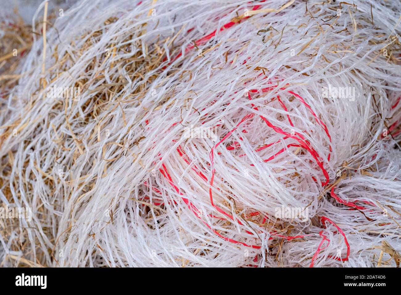 Pile of garbage, plastic threads of packing material of straw in a ...