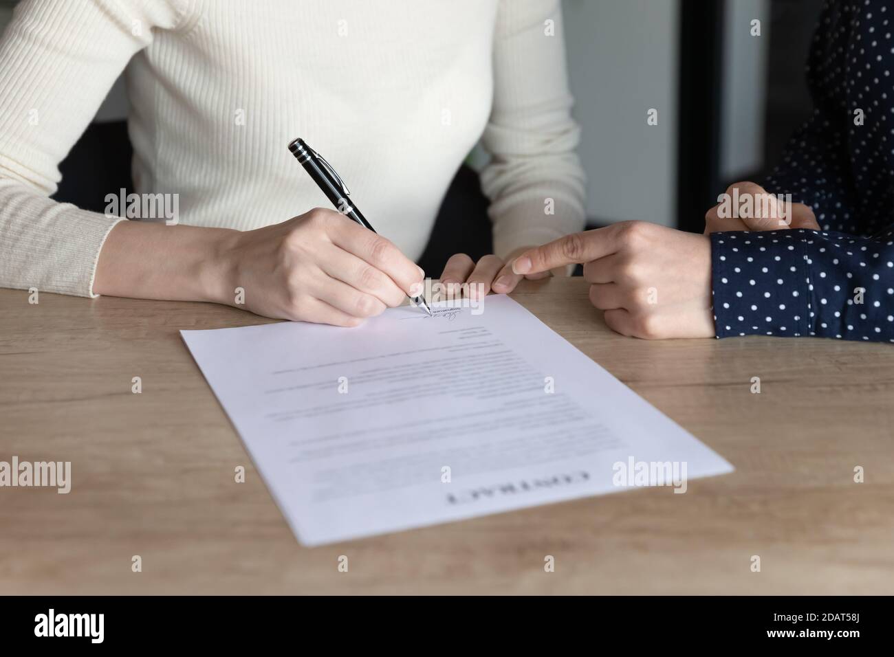 Close up woman signing contract, making deal with Indian manager Stock ...