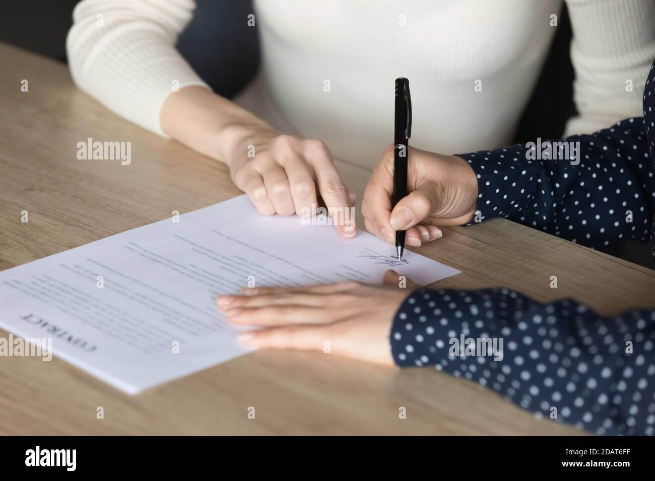 Close up Indian woman signing contract, manager pointing finger Stock ... Close up Indian woman signing contract, manager pointing finger Stock ...