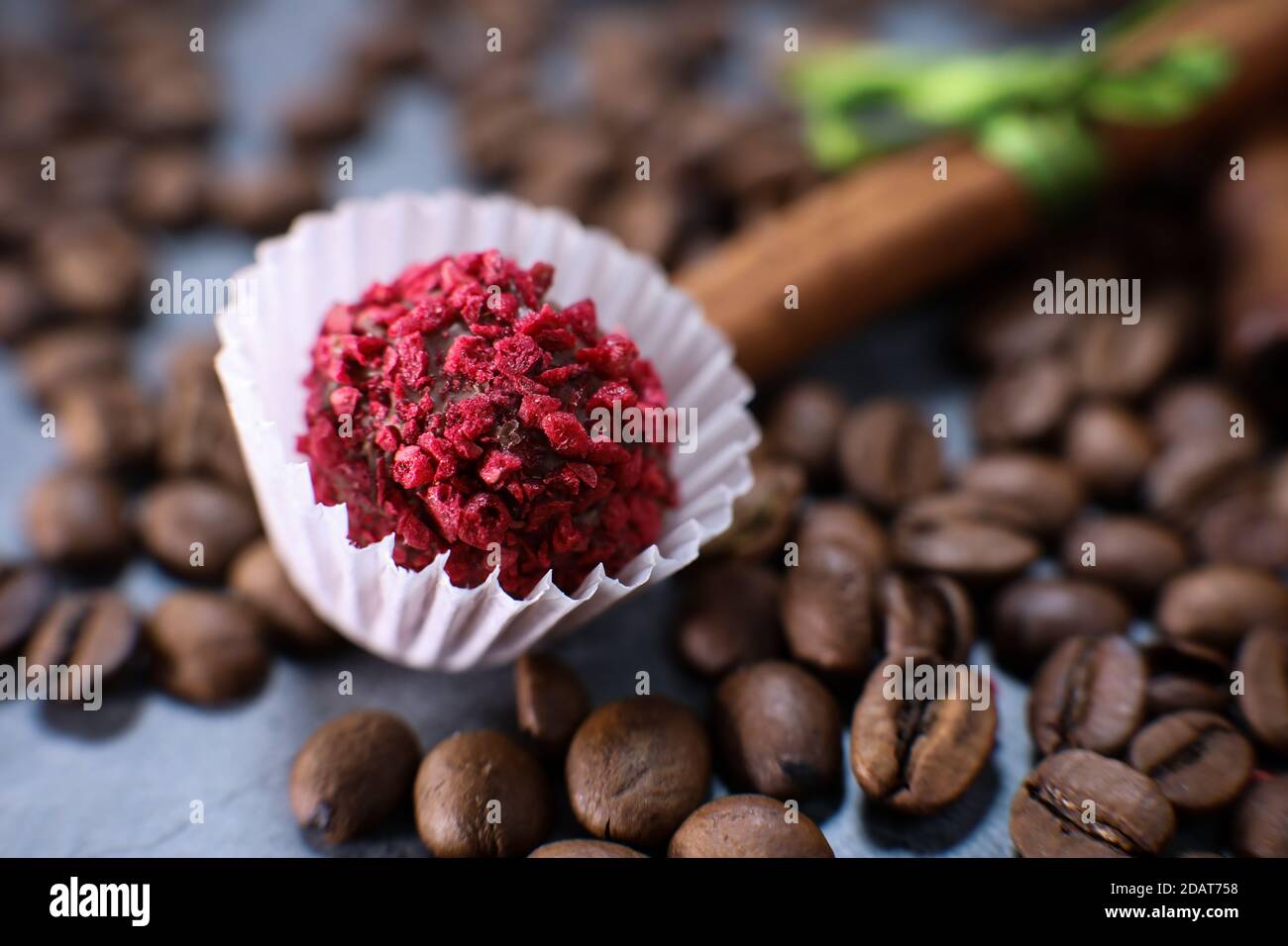 Red chocolate candy close up against coffee beans background. Morning ...