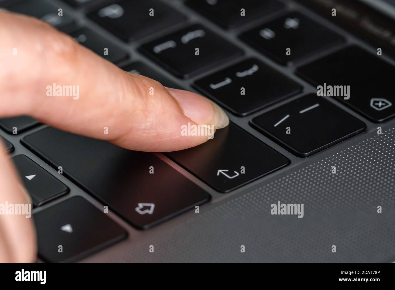 close-up female hand pressing enter button on a laptop keyboard Stock ...