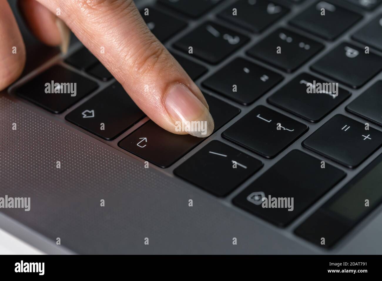 close-up female hand pressing enter button on a laptop keyboard Stock ...