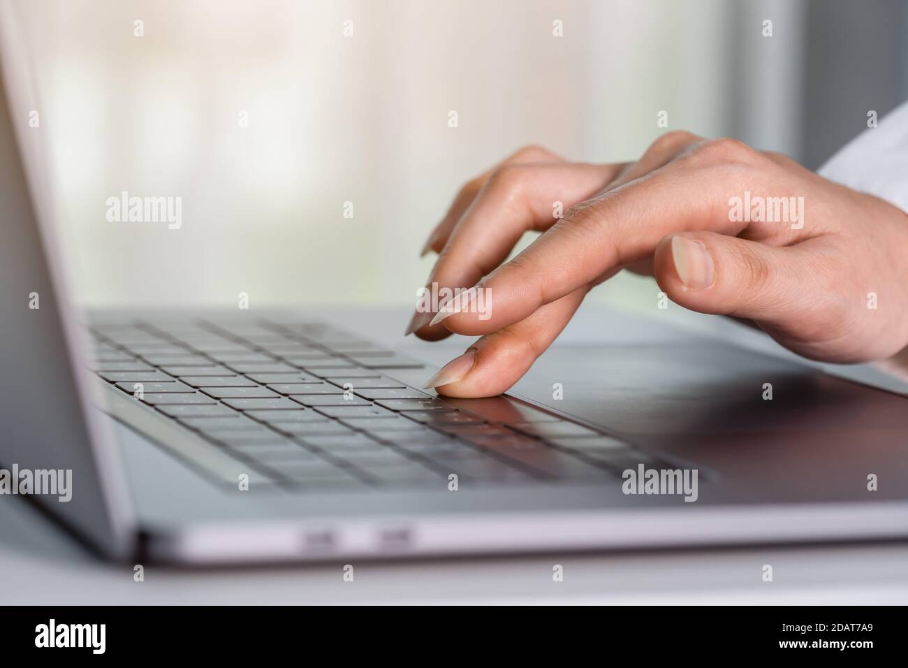 close-up female hand pressing space bar button on a laptop keyboard ...