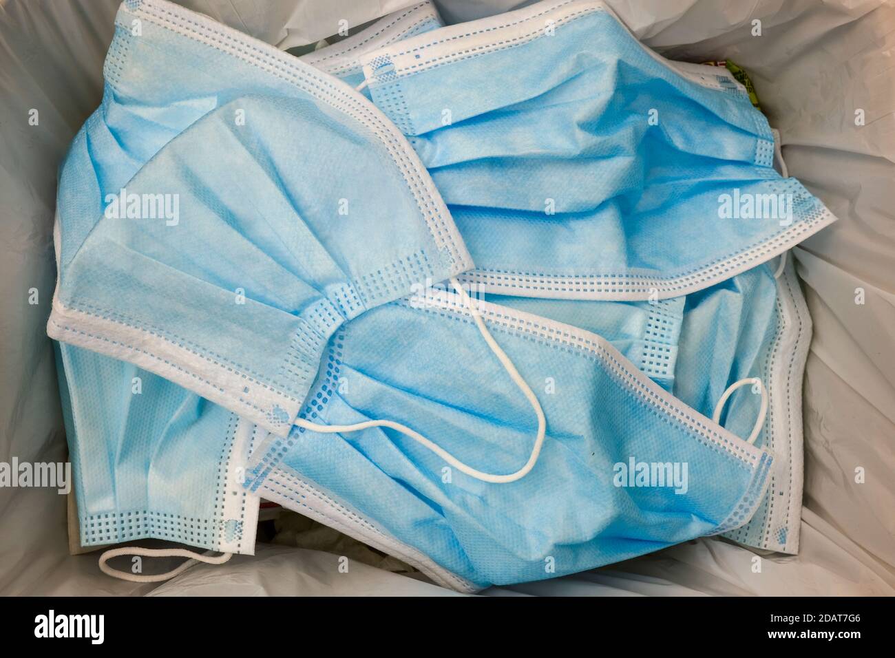 A trash basket filled with disposable face masks view from above Stock ...