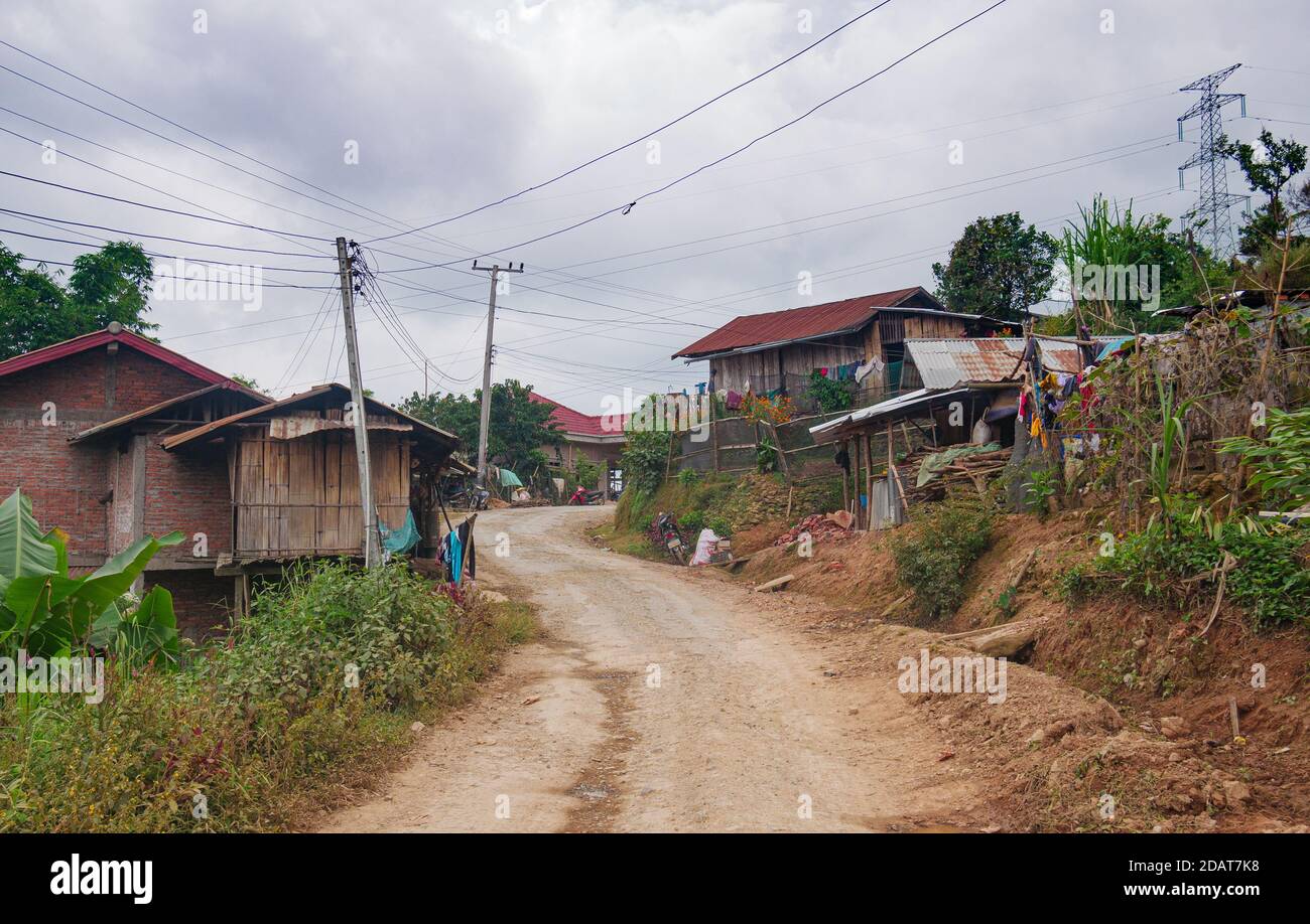 Akha village in the mountains of North Laos, sunset dramatic sky ...