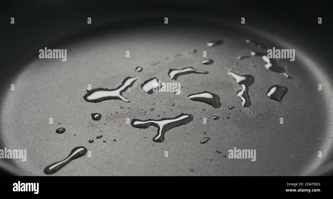 Non stick pan surface with oil, wide photo Stock Photo - Alamy