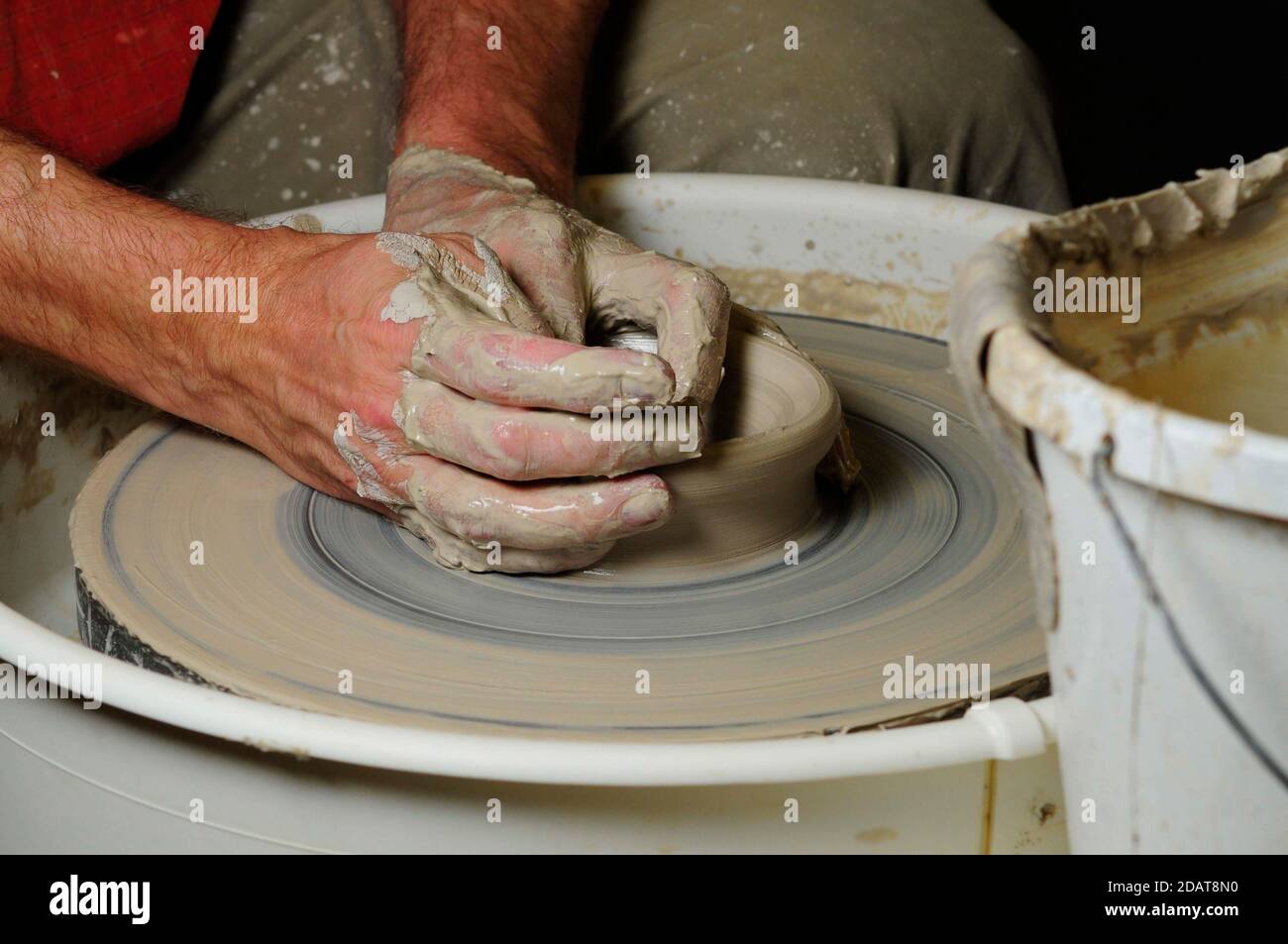 man making pottery with his hand on a pottery wheel Stock Photo - Alamy
