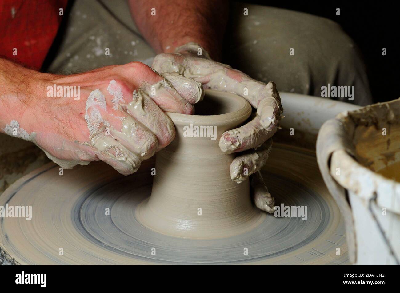 man making pottery with his hand on a pottery wheel Stock Photo - Alamy
