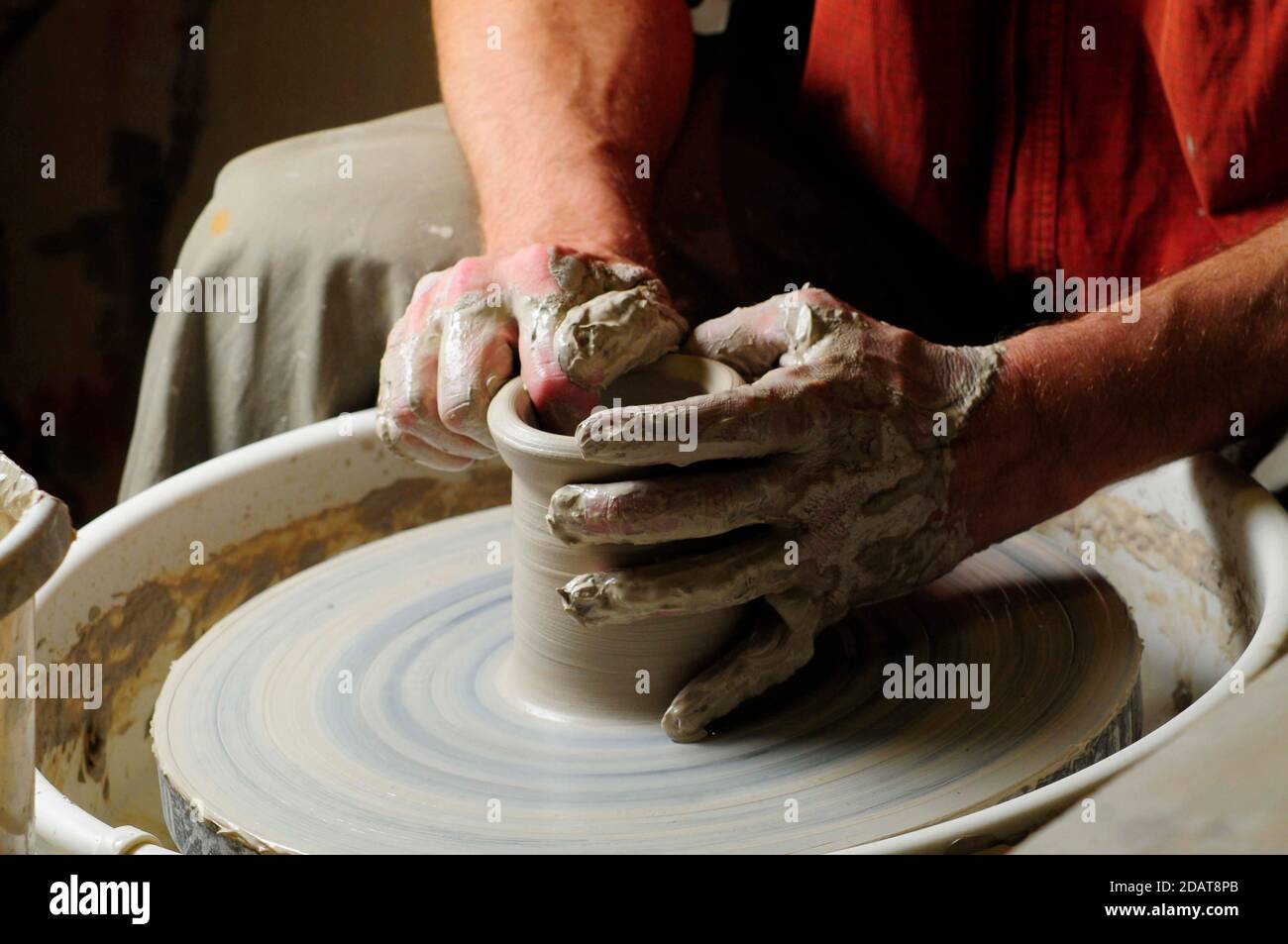 man making pottery with his hand on a pottery wheel Stock Photo - Alamy