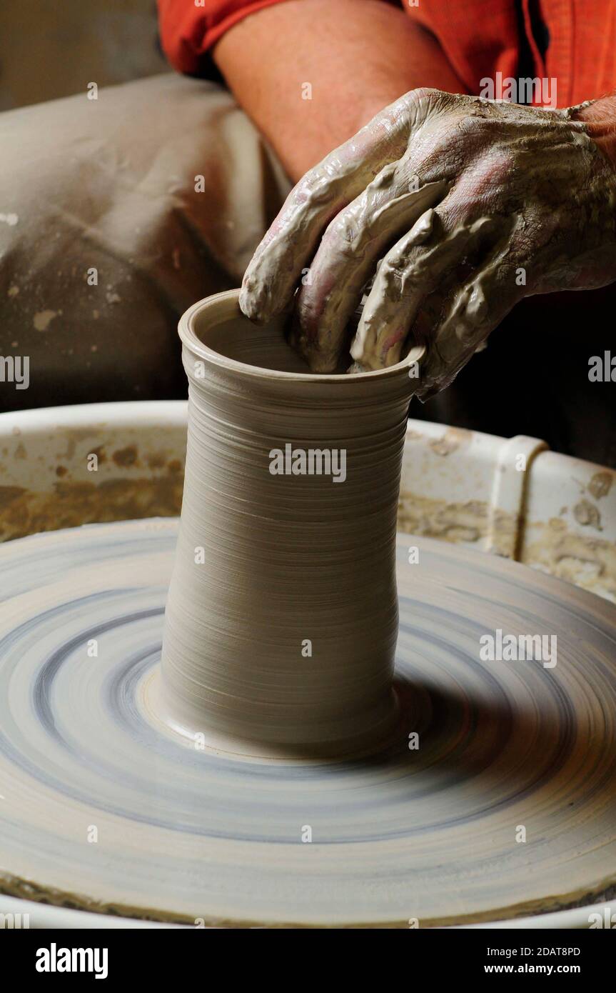man making pottery with his hand on a pottery wheel Stock Photo - Alamy