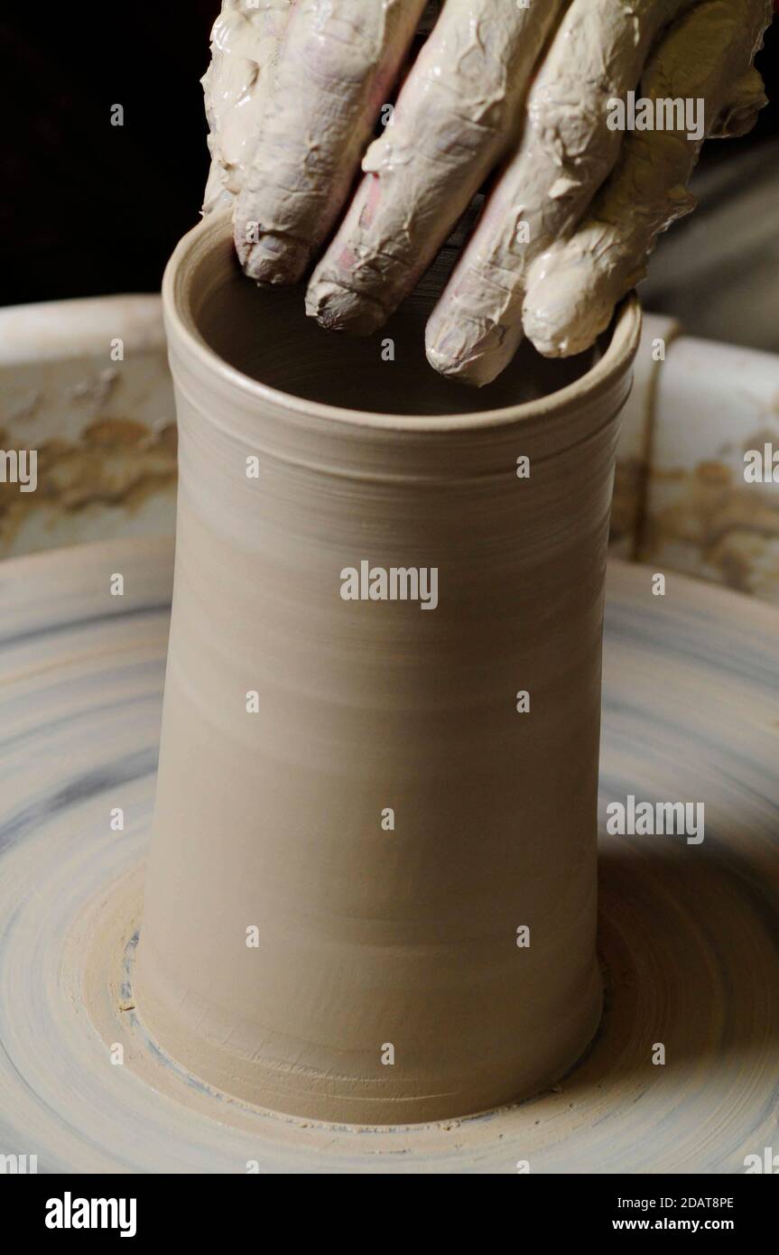 man making pottery with his hand on a pottery wheel Stock Photo - Alamy