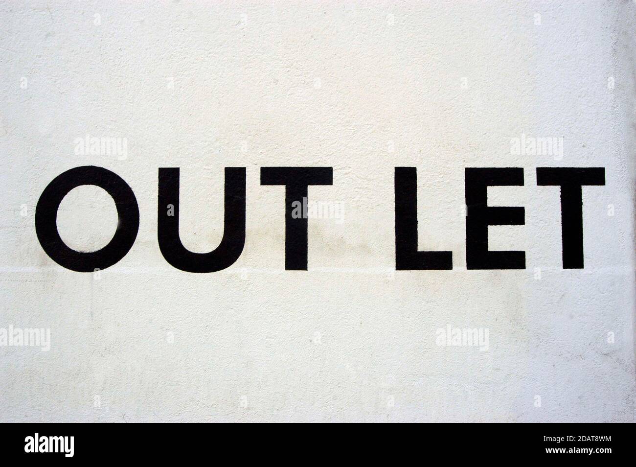 designer outlet sign on a wall, black letters on white background Stock ...