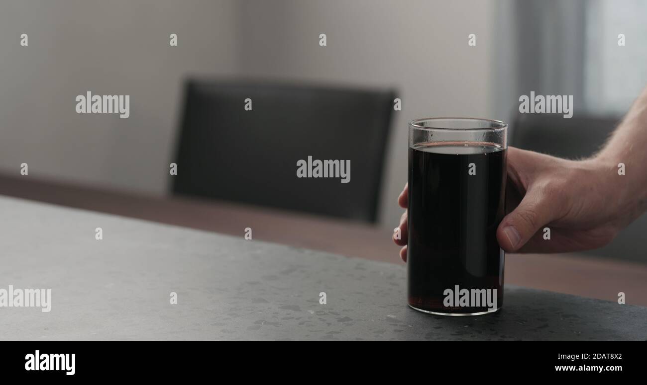 Slow motion man hand take cola in highball glass with crushed ice from ...