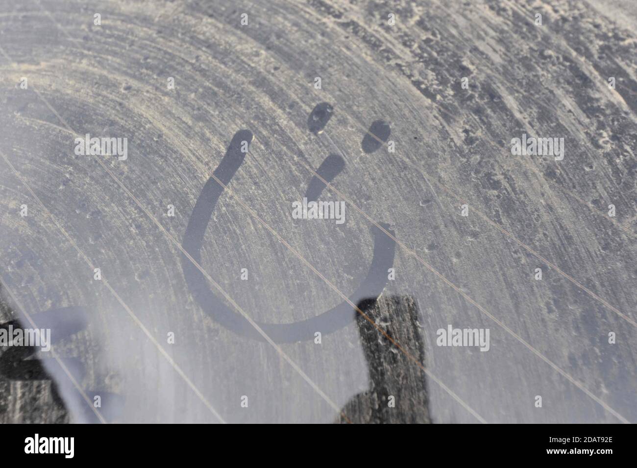 a smiling face on a dusty window, symbol for laughter and joy Stock ...