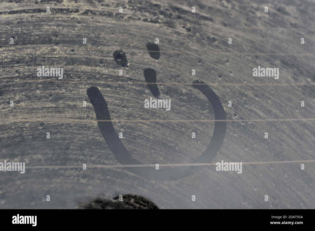 a smiling face on a dusty window, symbol for laughter and joy Stock ...