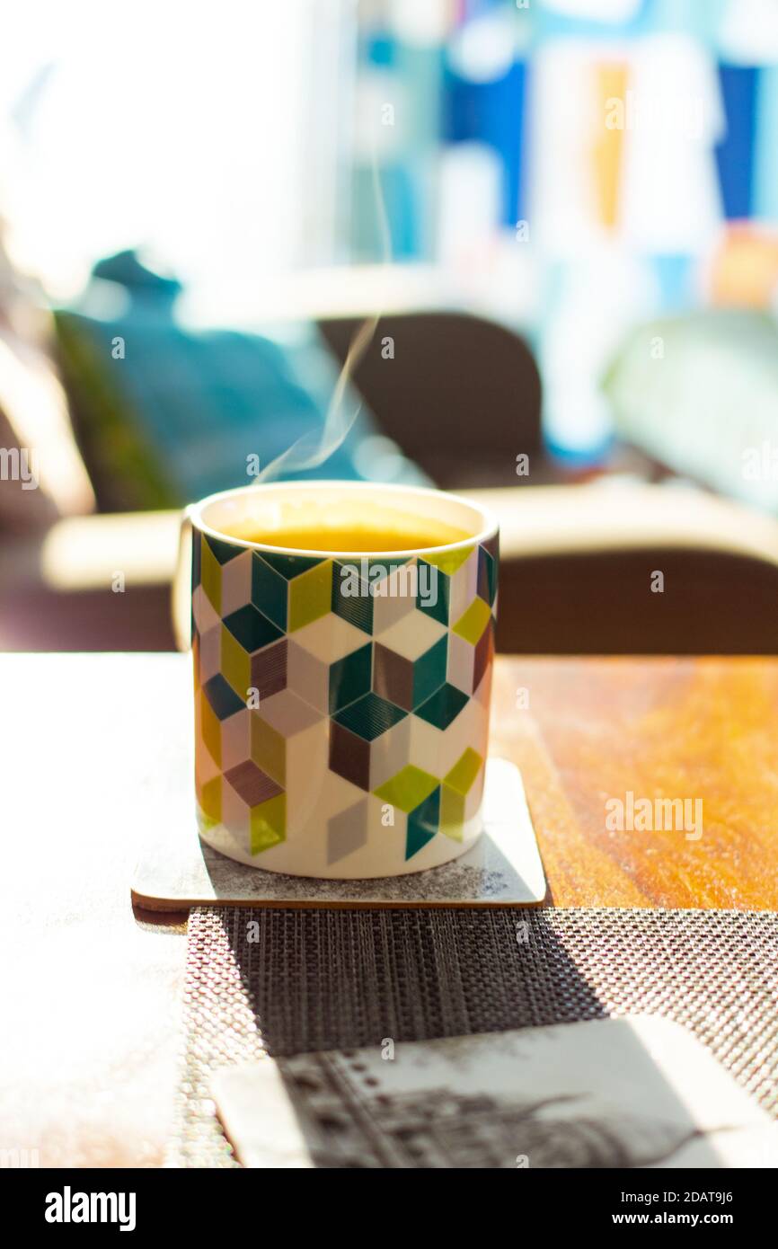 A cup of tea with steam visible in sunlight Stock Photo - Alamy