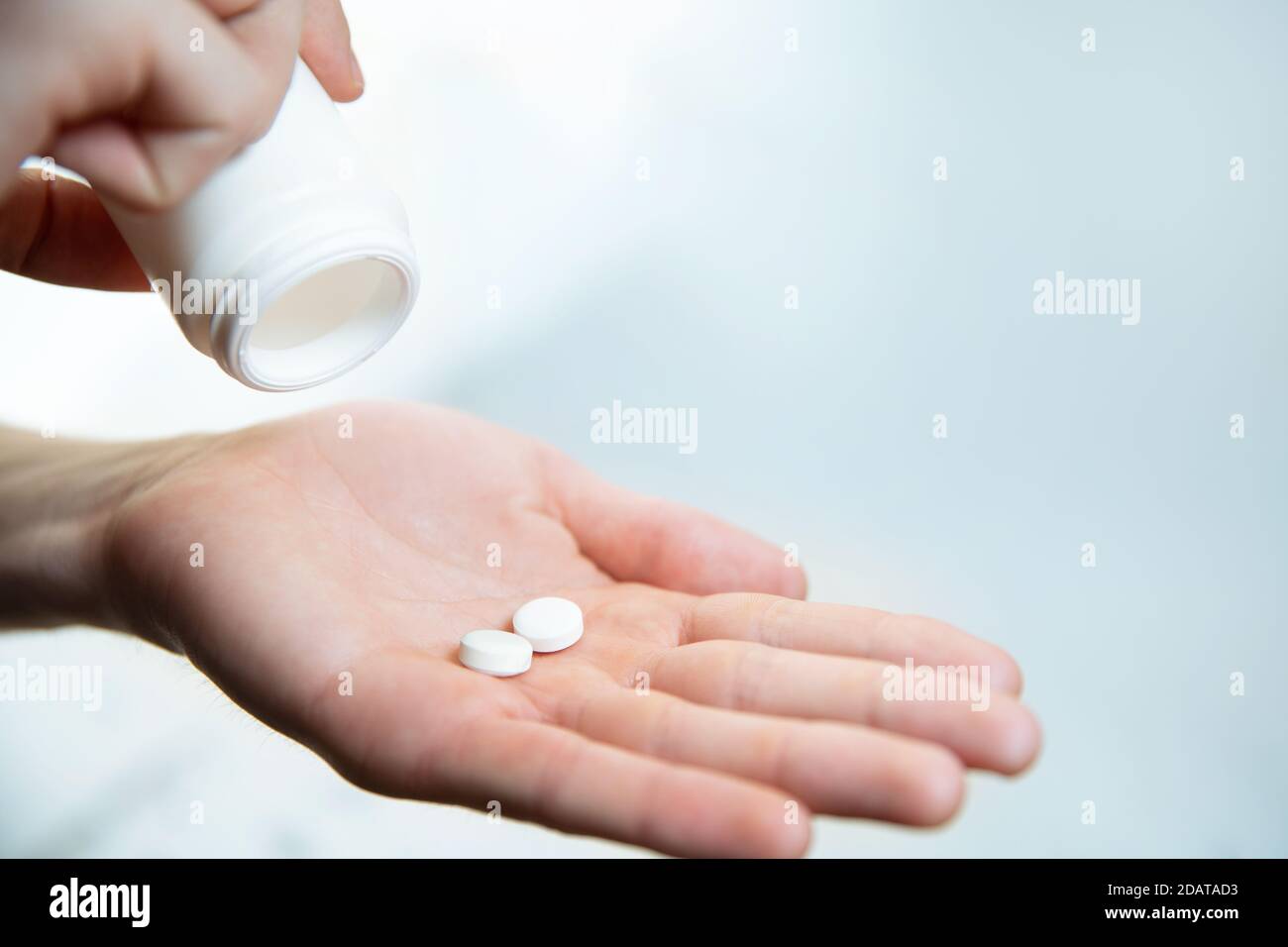 close up. two tablets in the palm of a person's hand Stock Photo - Alamy