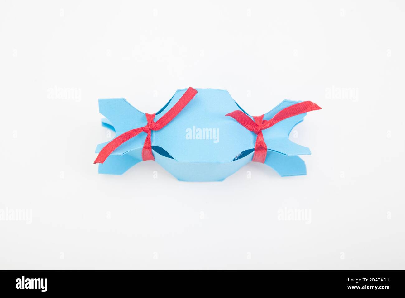 Blue original candy package with red ribbons on white background Stock ...