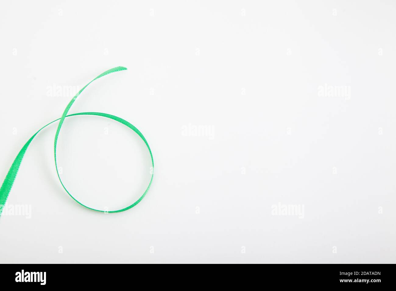 Curved green wavy ribbon on white with copy space Stock Photo - Alamy