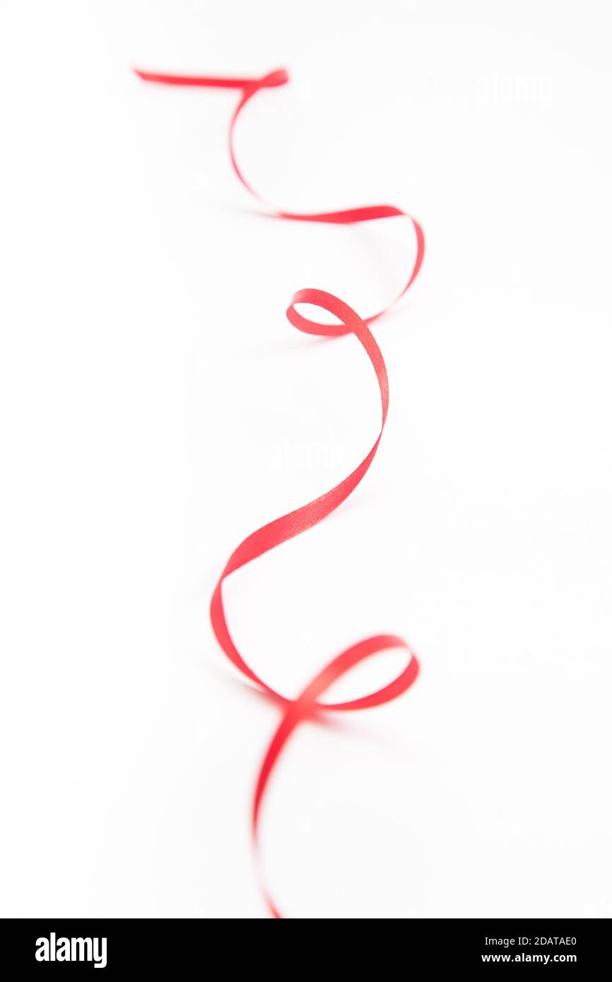 Vertical red wavy ribbon on white with copy space Stock Photo - Alamy