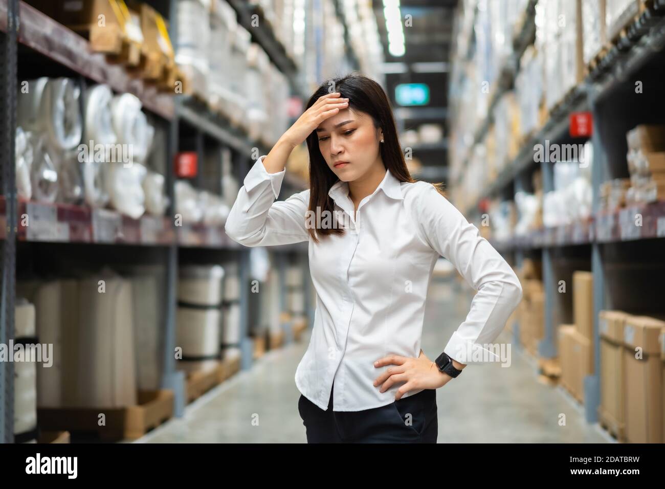 stressed female manager in the warehouse store Stock Photo - Alamy