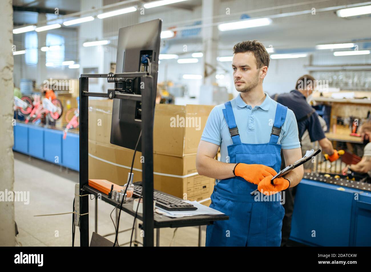 Bicycle factory, worker poses at assembly line Stock Photo - Alamy