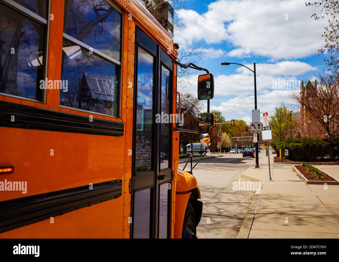 Orange school bus on USA city street view of the front door Stock Photo ...