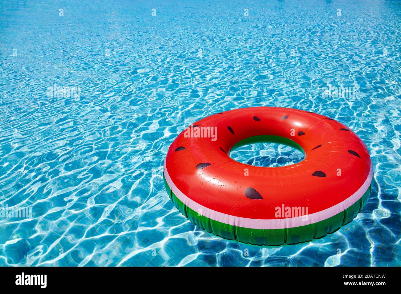 Inflatable watermelon buoy swim in the swimming pool view with ...