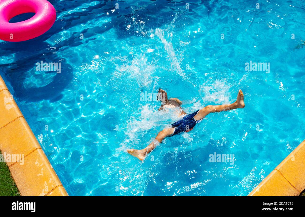 Boy falls into the pool water backwards splashes view from above Stock ...