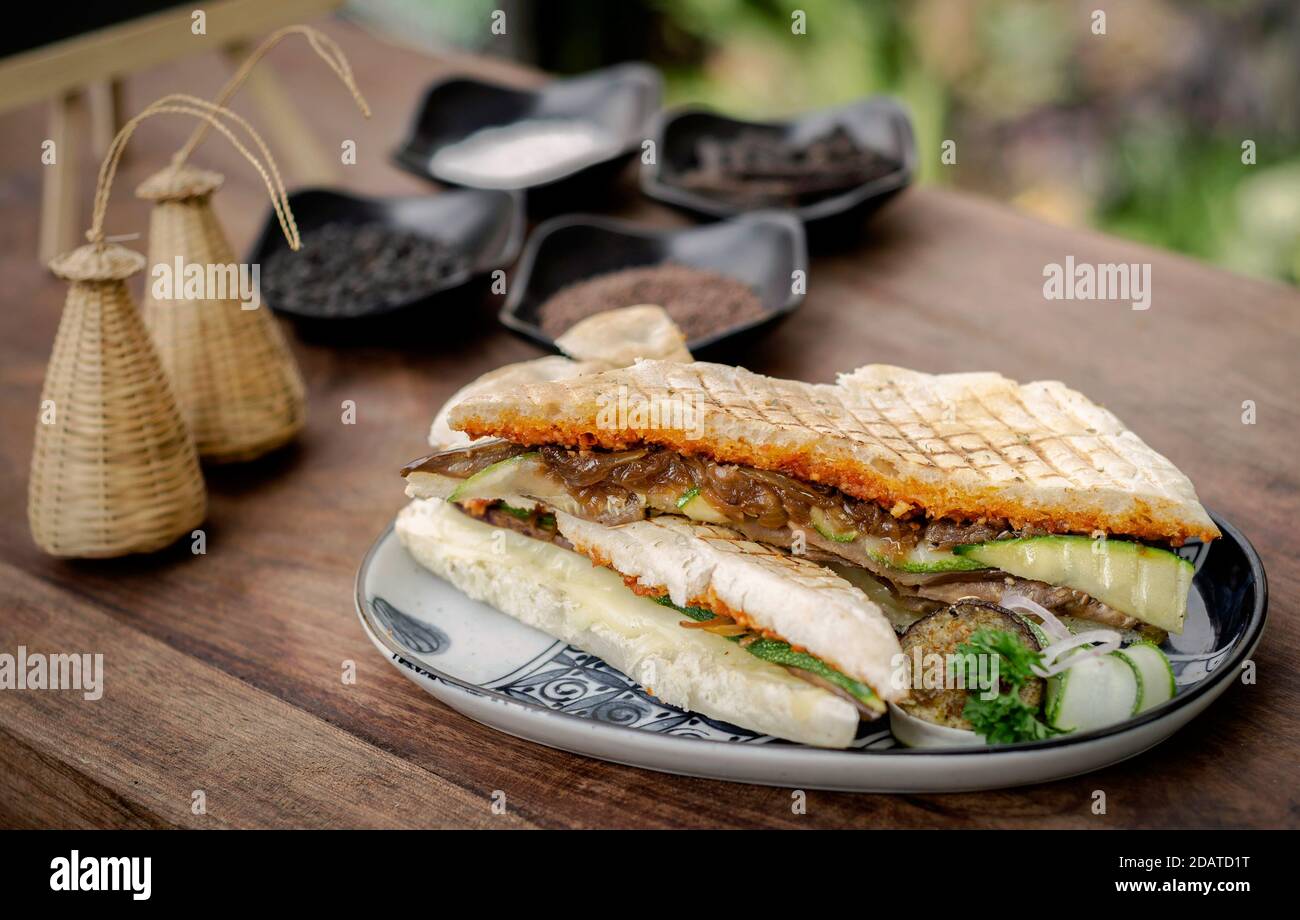 vegan roasted vegetable toasted panini sandwich in rustic garden table ...