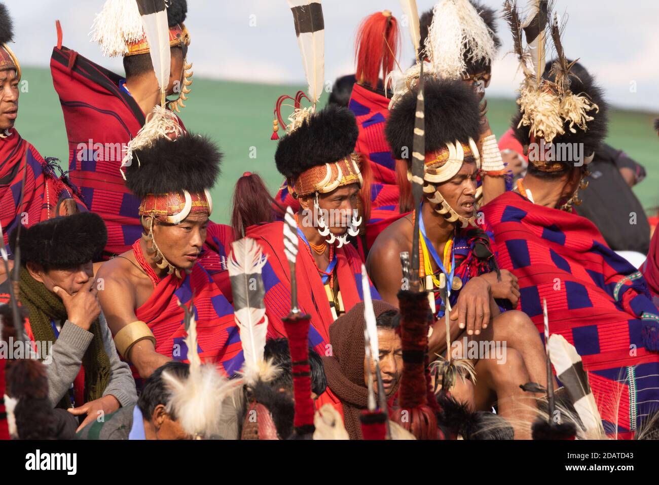 Naga tribesmen wearing their traditional attire and siting together in ...