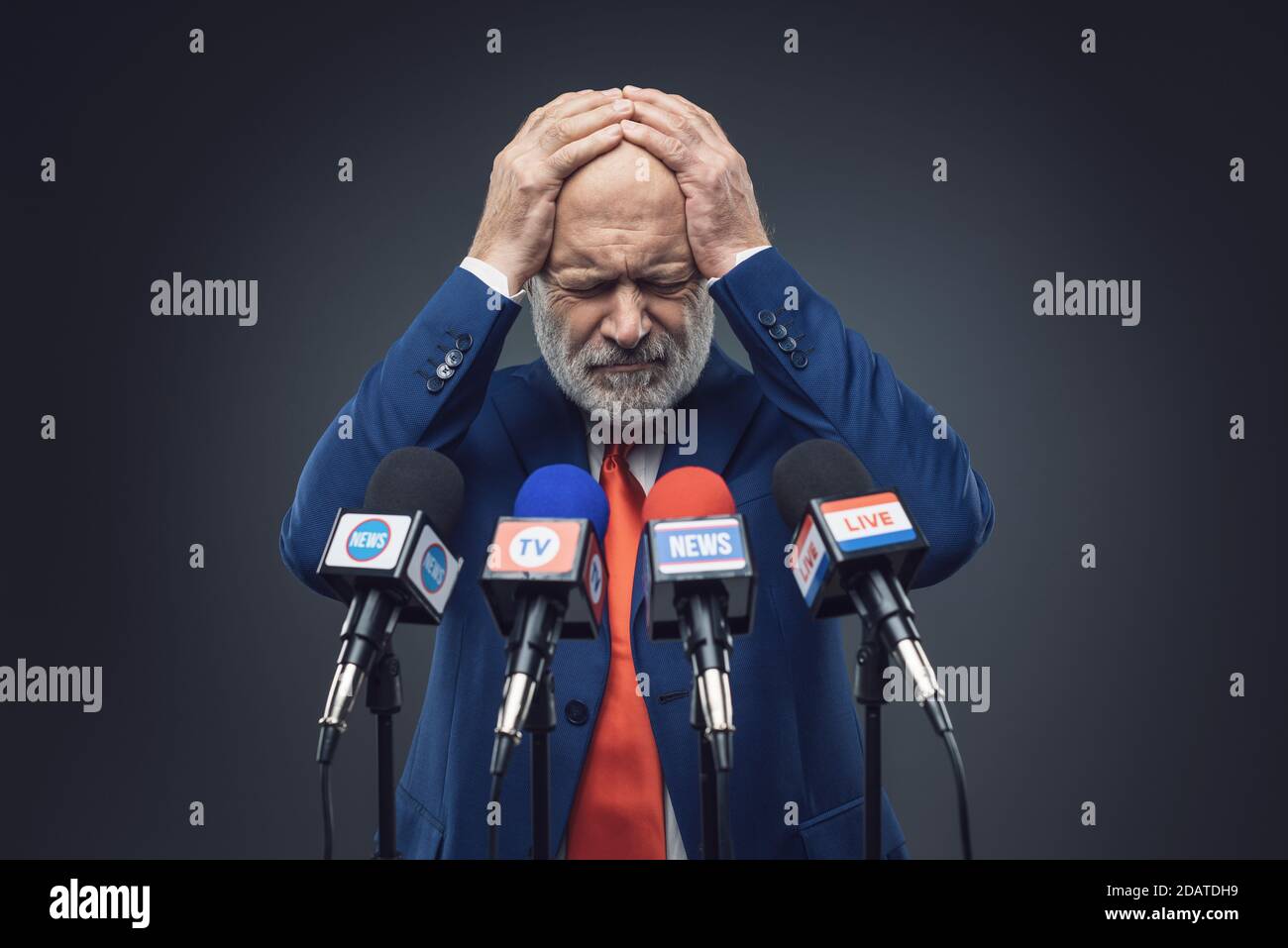 Sad politician with head in hands at the media briefing, he feels ...
