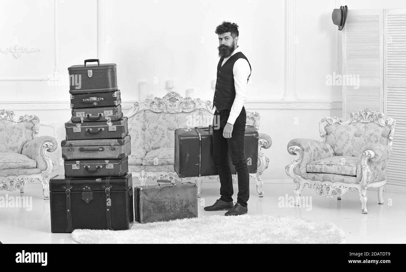 Macho elegant on strict face carries vintage suitcase. Luggage and ...