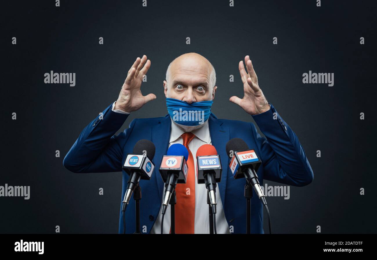 Angry politician with sealed mouth at the press conference, censorship ...