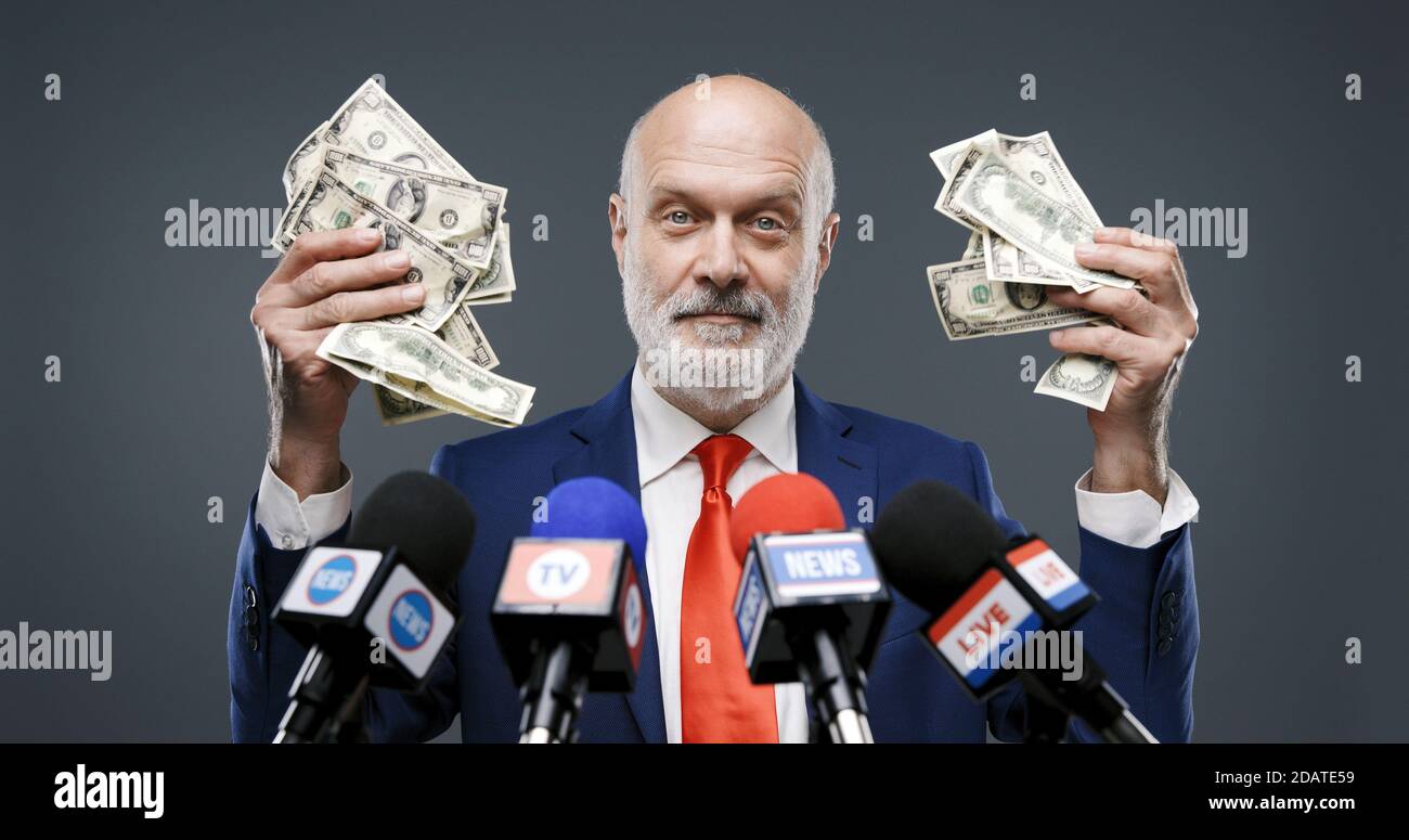 Politician and lots of cash dollars, economy and corruption concept ...