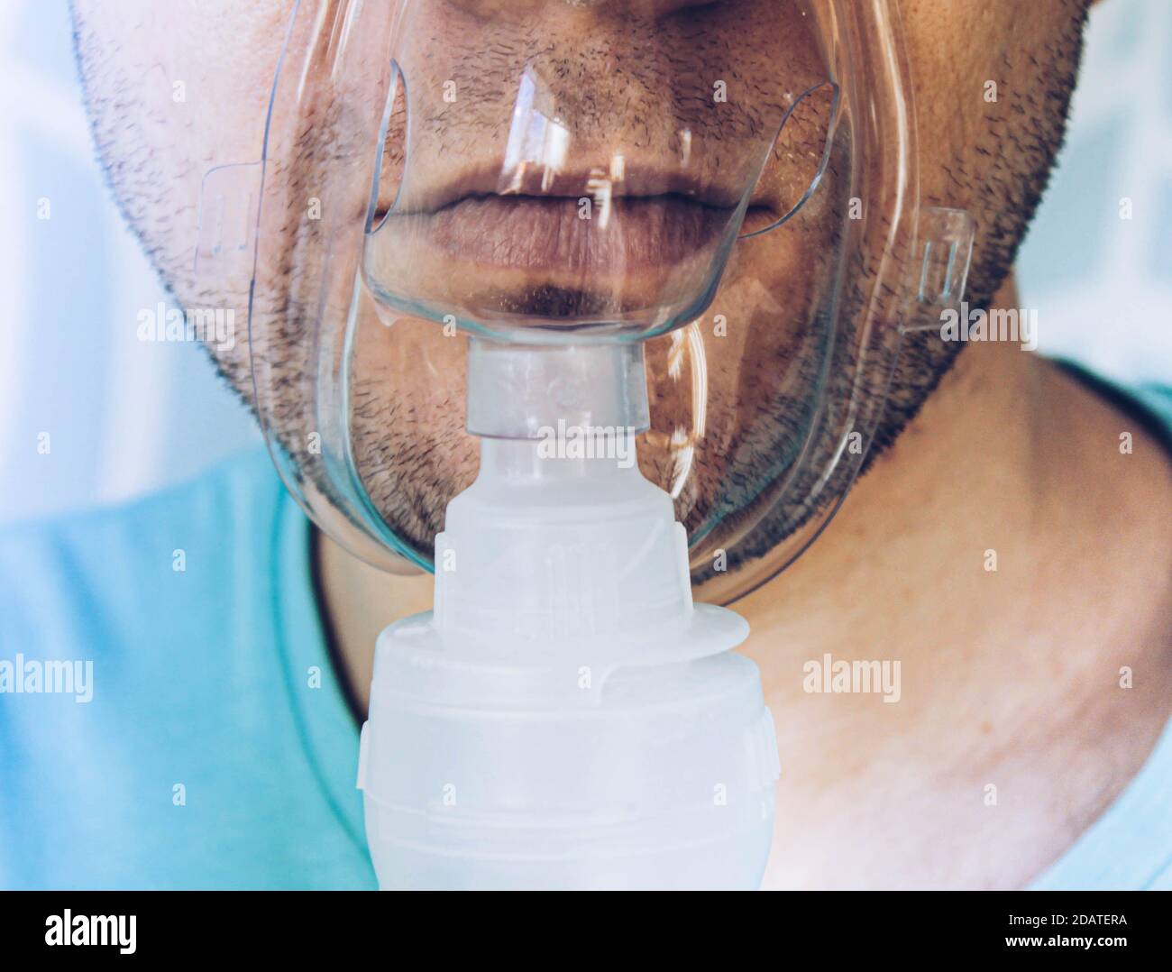 A man with an inhalation mask on his face Stock Photo - Alamy