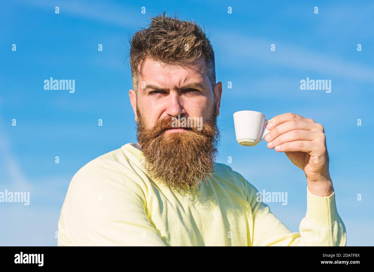 Bearded man with espresso mug, drinks coffee. Man with beard and ...