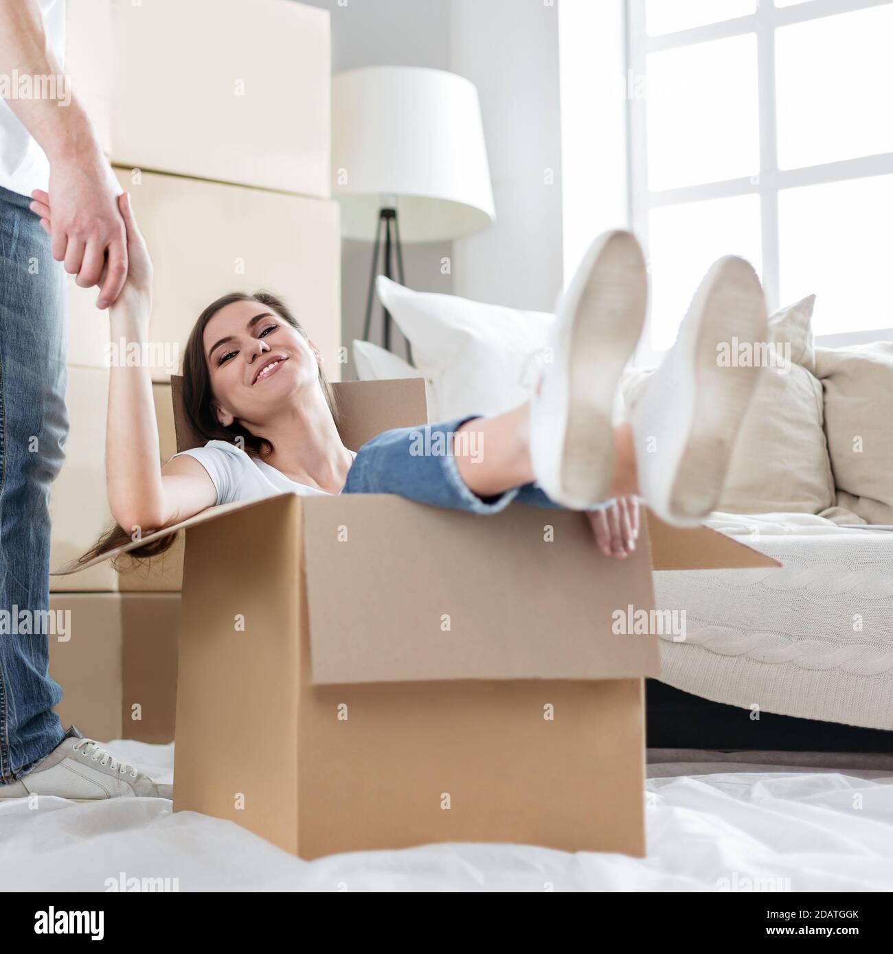 Happy family unpacking cardboard boxes hi-res stock photography and ...
