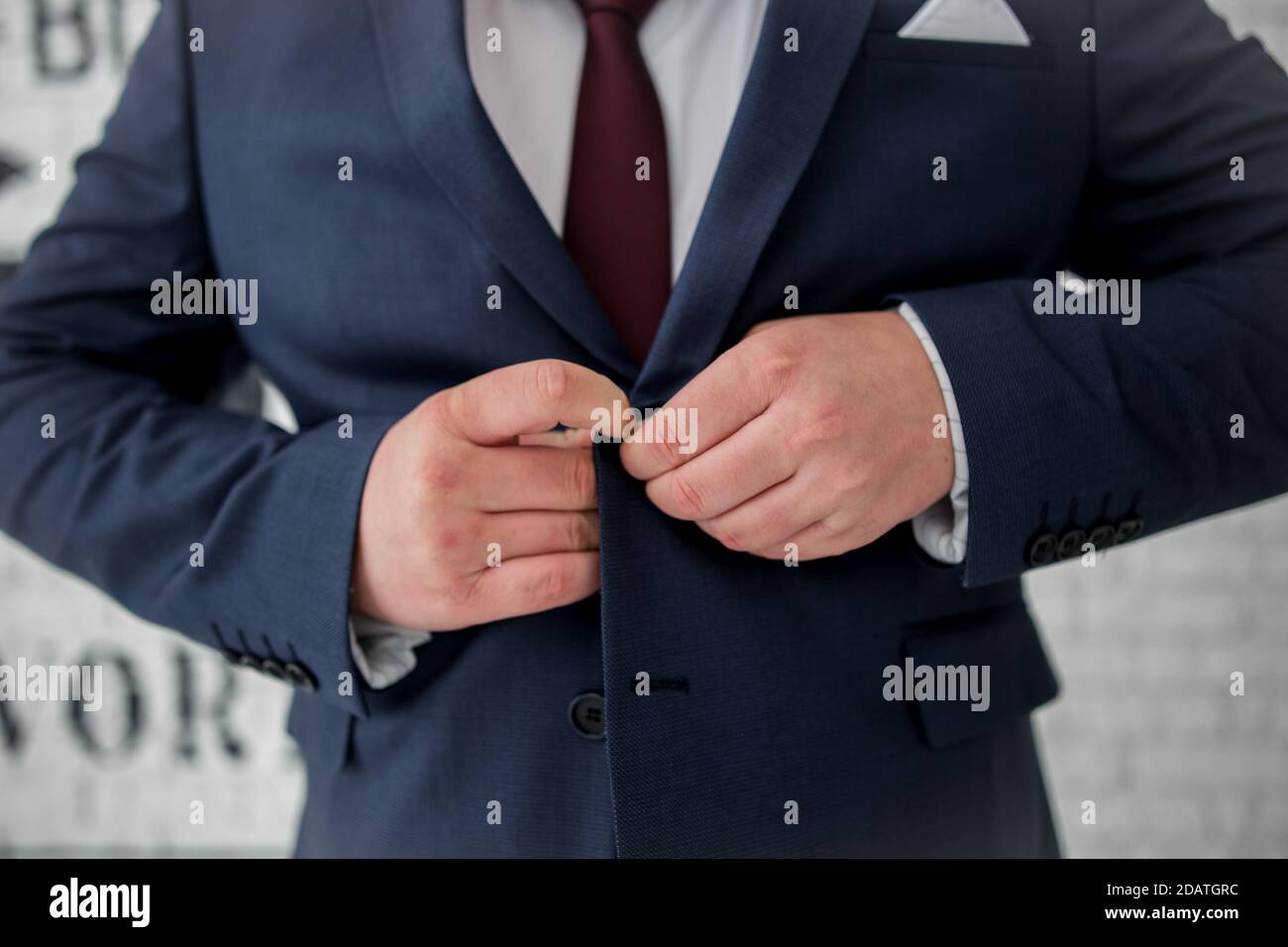 man buttons a jacket from a suit Stock Photo - Alamy
