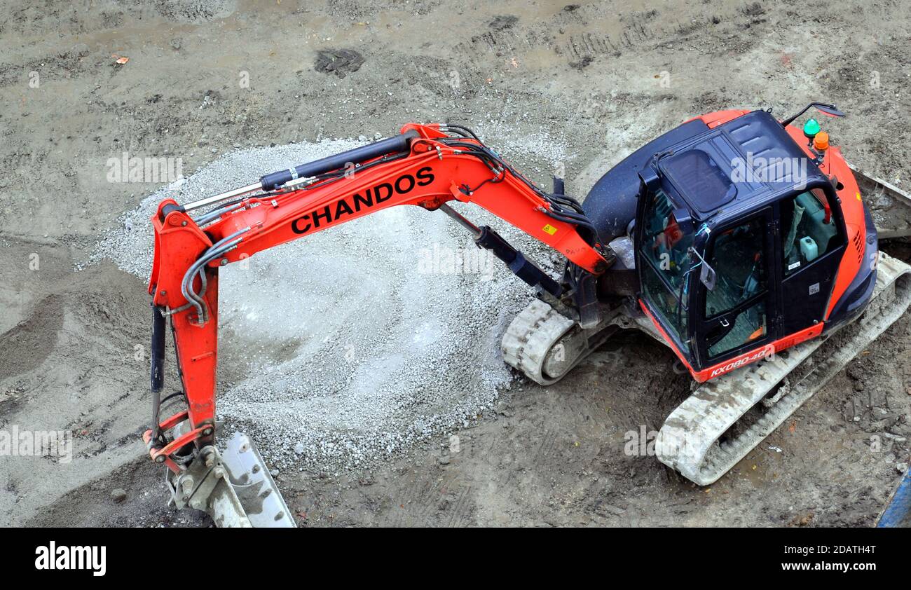 Overhead view of a construction digger and a pile of gravel on a ...