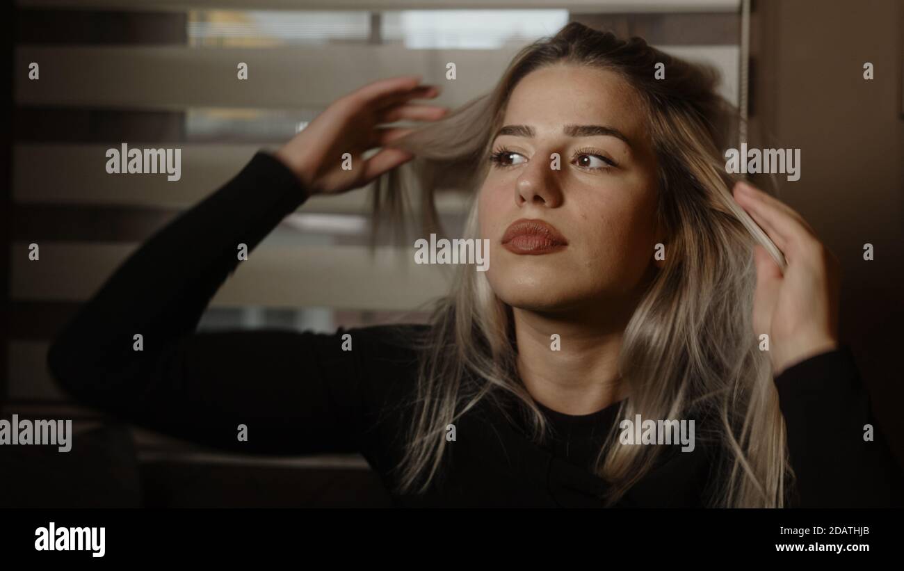 Young bored blonde woman poses looking at camera, lifestyle and ...