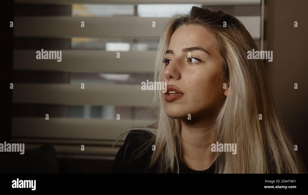 Young bored blonde woman poses looking at camera, lifestyle and ...