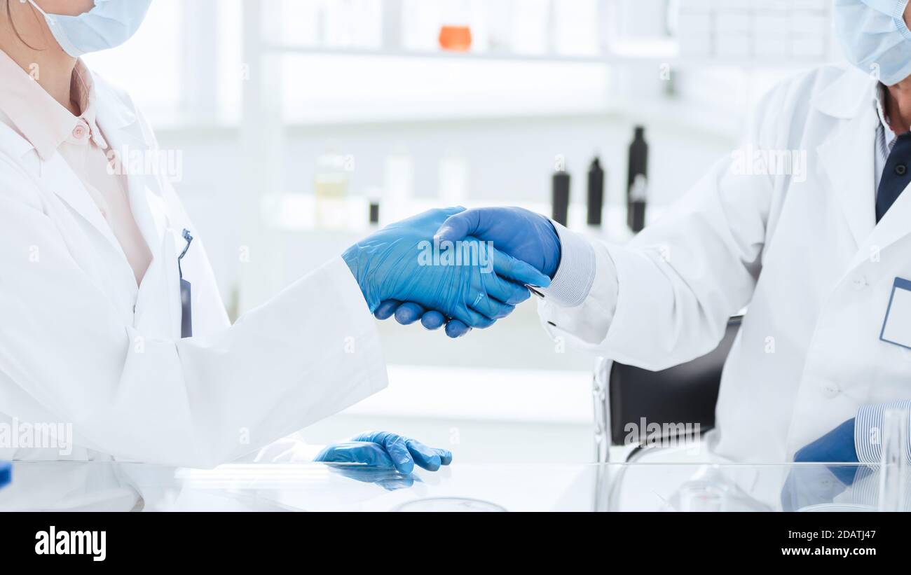 close up. Microbiology scientists shaking hands. science and health ...