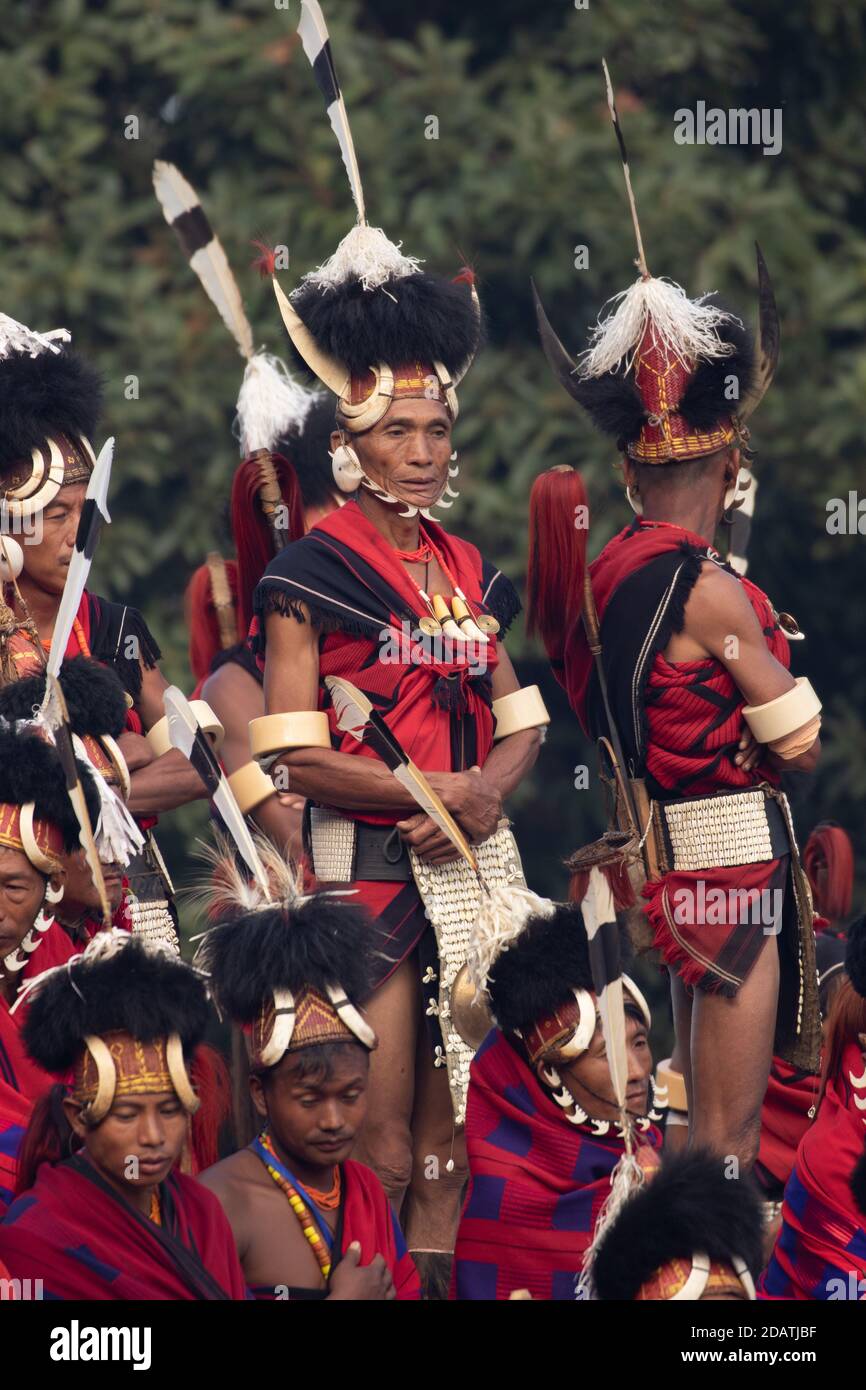 Naga tribesmen wearing their traditional attire and siting together in ...