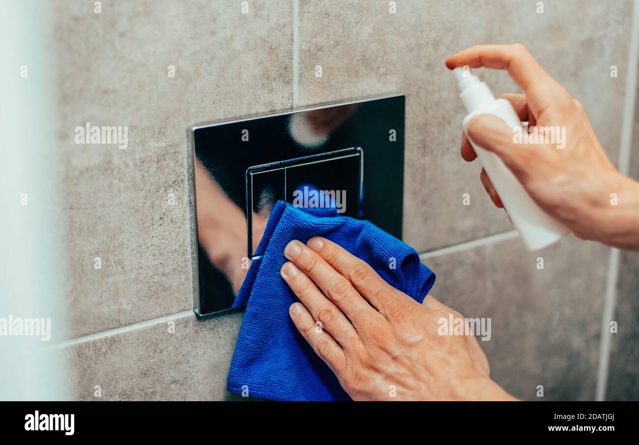 close up. man spraying an antibacterial spray on a wall switch Stock ...